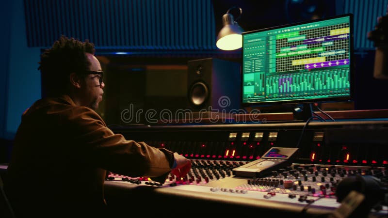 African American Producer Working at Mixing Panel in Recording Studio ...