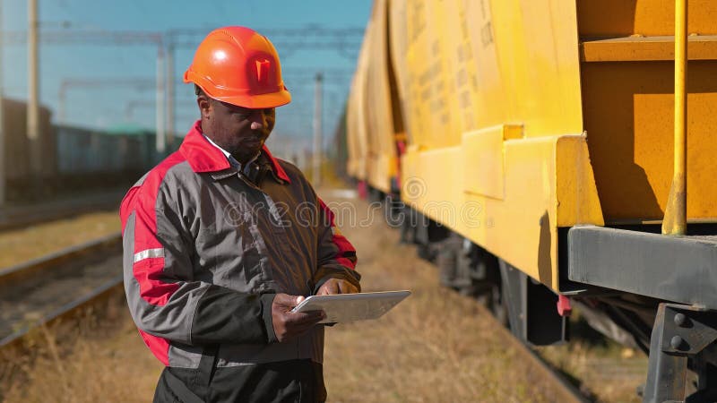 Afro-american Railway Man with Tablet Computer at Freight Train ...