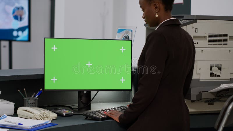 Receptionist Using Computer with White Isolated Screen at Reception ...