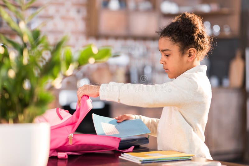 Schoolgirl Packing Backpack And Preparing For School Stock Image ...