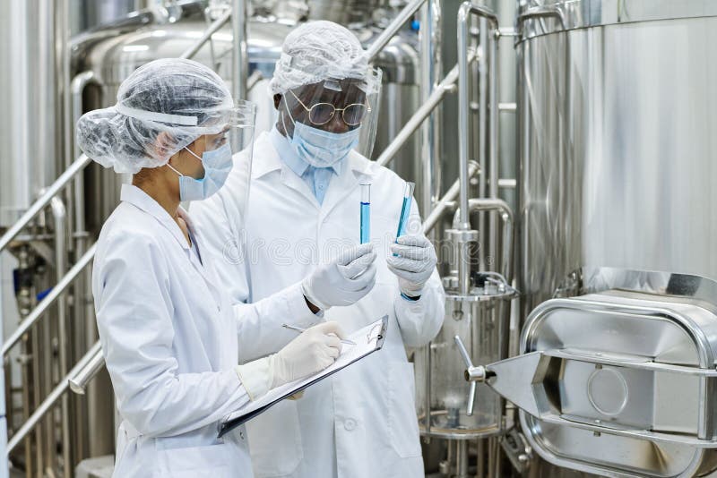 Scientists Examining Analysis and Writing Results Stock Photo - Image ...