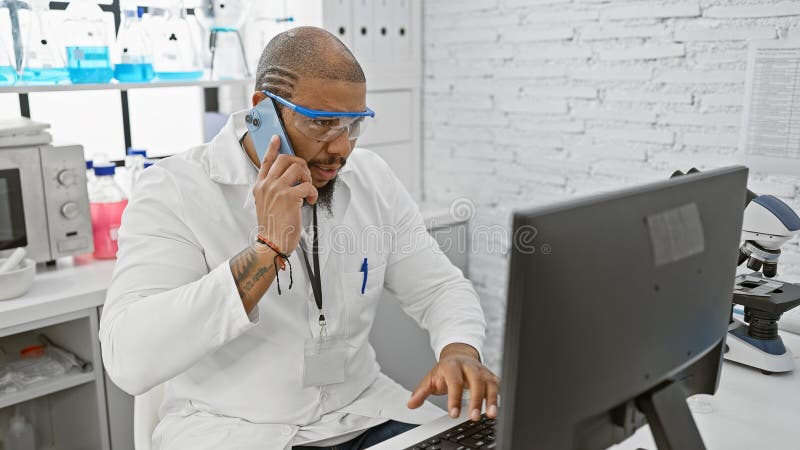 African American Scientist in Lab Coat Talking on Phone while Working ...