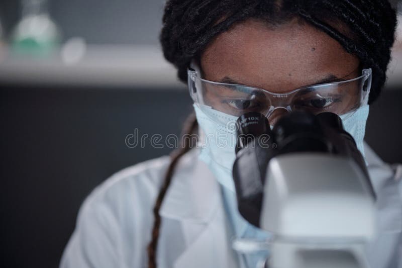 African American Scientist Observing Sample through Microscope Stock ...