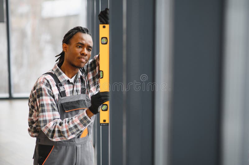 African American Skilled Technician Using Level for Precise ...