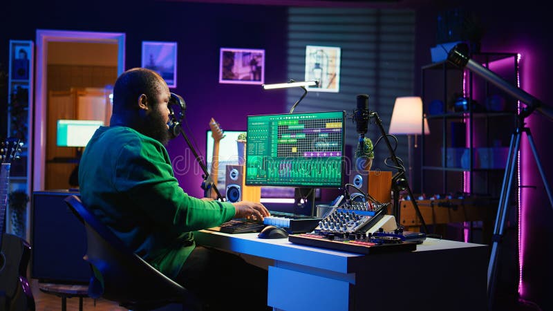 African American Sound Engineer Using Midi Controller Notes To Add ...