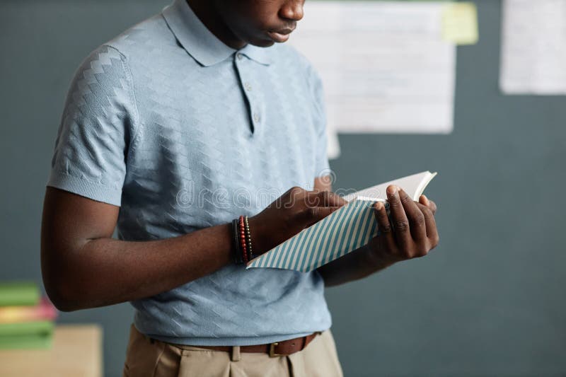 African American Student Holding Notebook Reading Notes while Studying ...