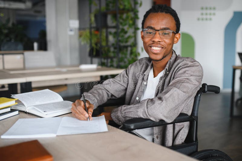 African American Student Writing in Wheelchair at Desk Stock Image ...