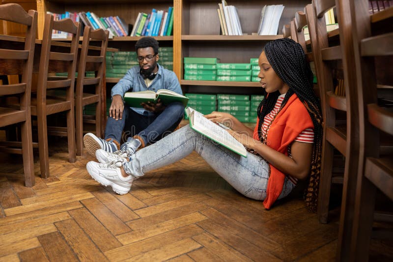 African American Students Reading Books while Sitting on the Floor in ...