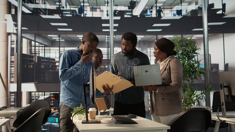 African American Team Collaborates on a Financial Project in a Business ...