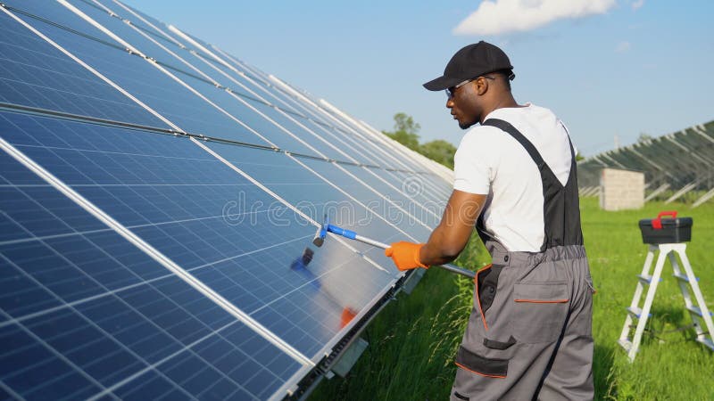 African American Technician are Cleaning Solar Panel Stock Footage ...