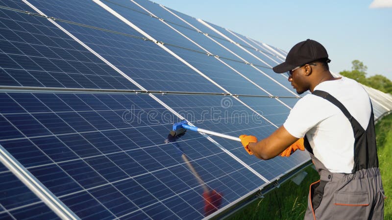 Cleaning Solar Panels.Man Washing Solar Panels from Dust and Dirt on ...