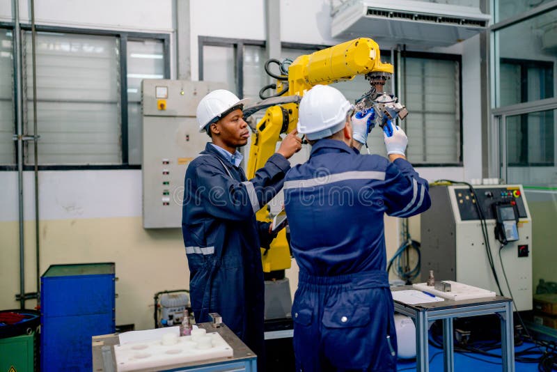 African American Technician or Engineer Point To Robotic Arm and Guide ...