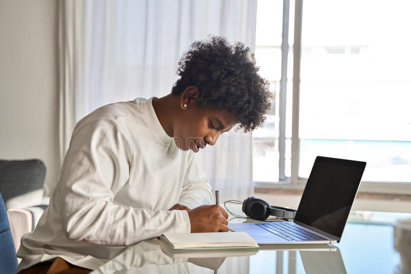 African American Teen Student Elearning, Writing Notes at Home. Stock ...