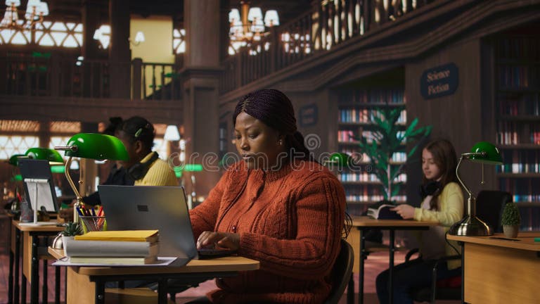 African American Tutor Preparing Documents and Learning Materials for ...