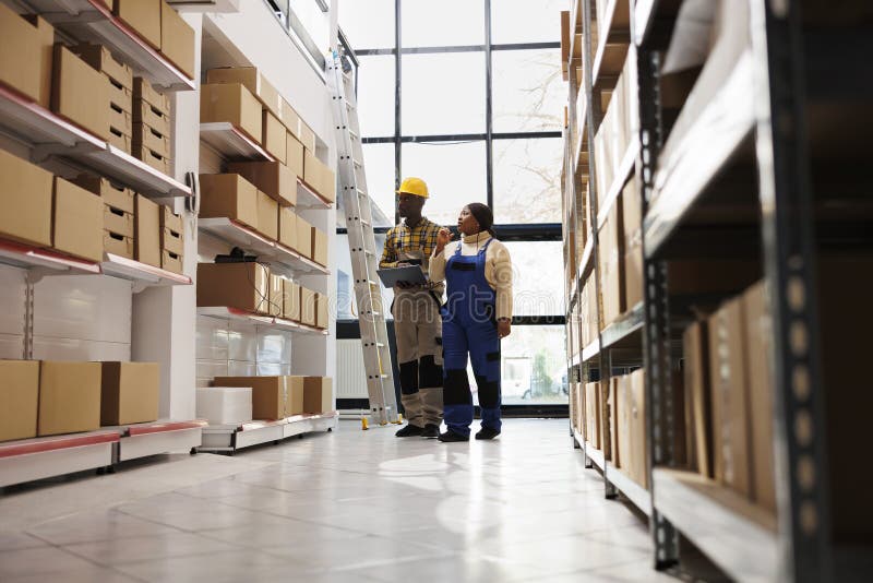 African American Warehouse Distribution Manager Doing Inventory with ...