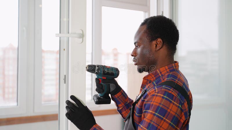 African American Windows Installation Worker in Uniform with ...