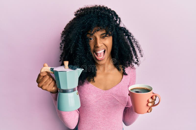 African American Woman With Afro Hair Drinking Italian Coffee Winking