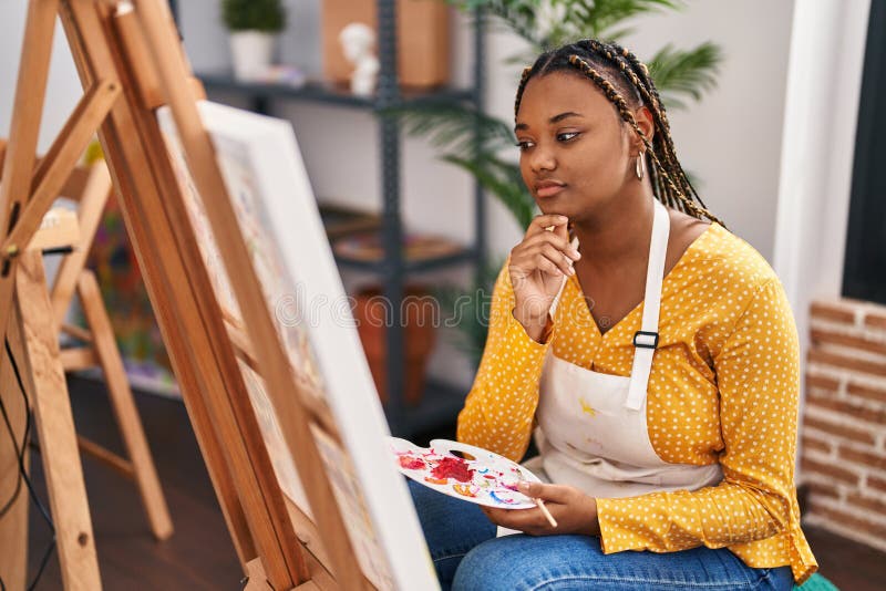 African American Woman Artist Drawing with Doubt Expression at Art ...