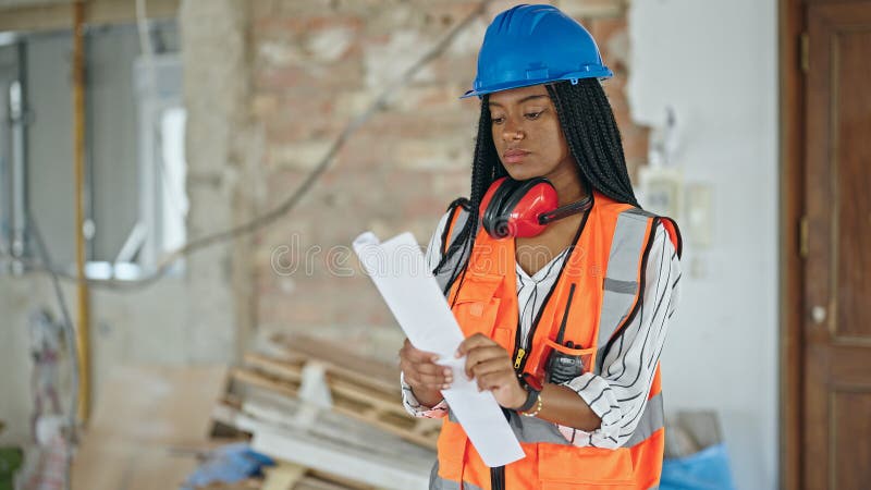 African American Woman Builder Standing with Relaxed Expression Reading ...