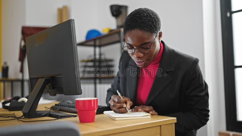 African American Woman Business Worker Using Computer Writing Notes at ...