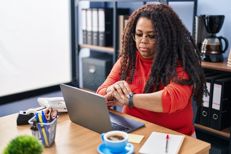 African American Woman Business Worker Using Laptop Looking Clock at ...
