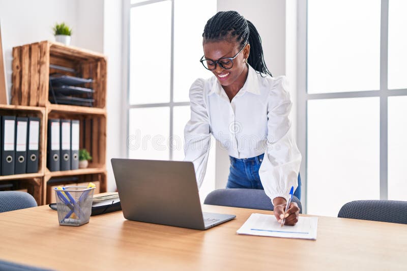 African American Woman Business Worker Using Laptop Writing on Document ...