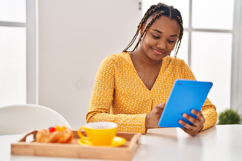 African American Woman Having Breakfast Using Touchpad at Home Stock ...