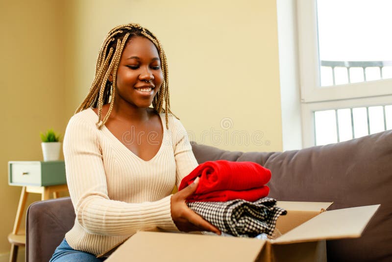 African American Woman Packing Things in a Box for Moving Stock Photo ...