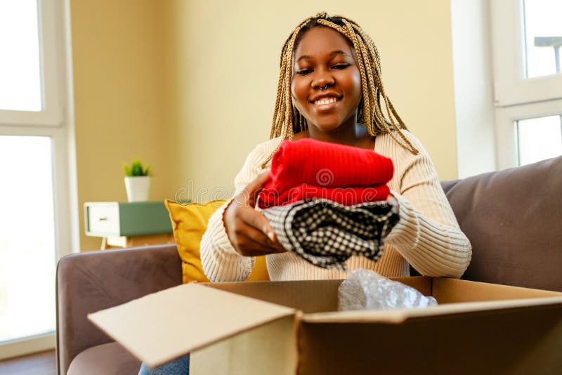 African American Woman Packing Things in a Box for Moving Stock Image ...