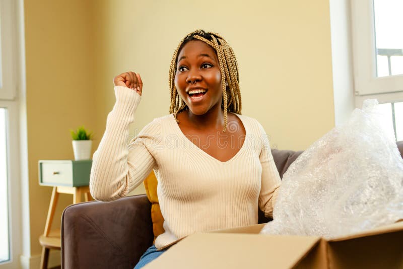 African American Woman Packing Things in a Box for Moving Stock Image ...