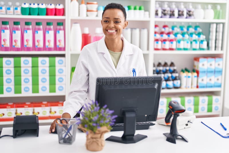 African American Woman Pharmacist Smiling Confident Using Computer at ...