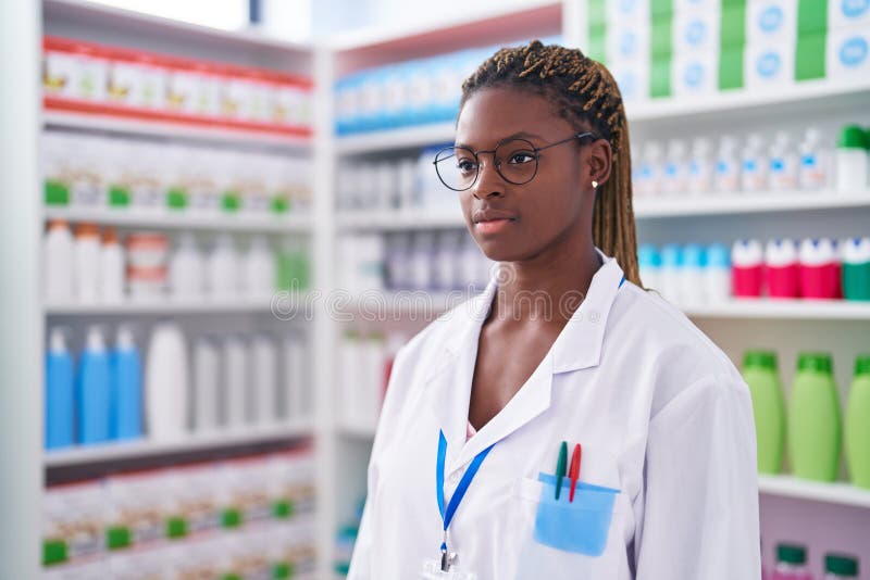 African American Woman Pharmacist Standing with Serious Expression at ...