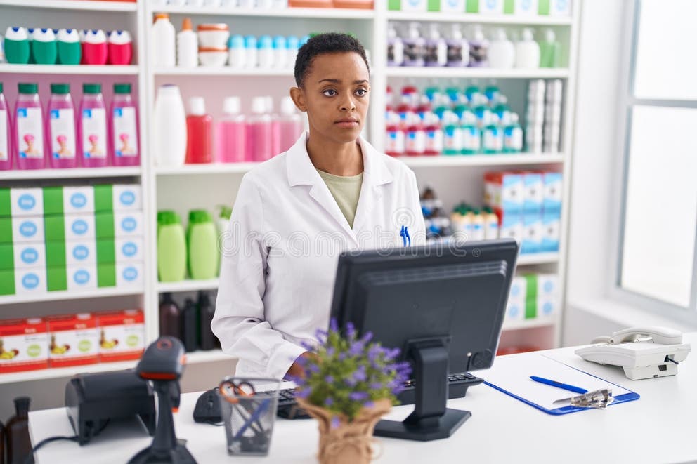 African American Woman Pharmacist Using Computer at Pharmacy Stock ...