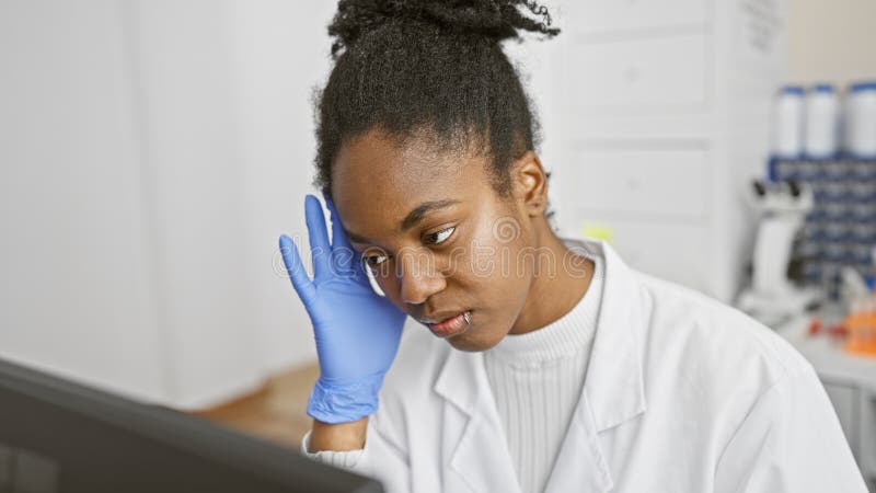 African American Woman Scientist in Lab Wearing Gloves Analyzing Data ...