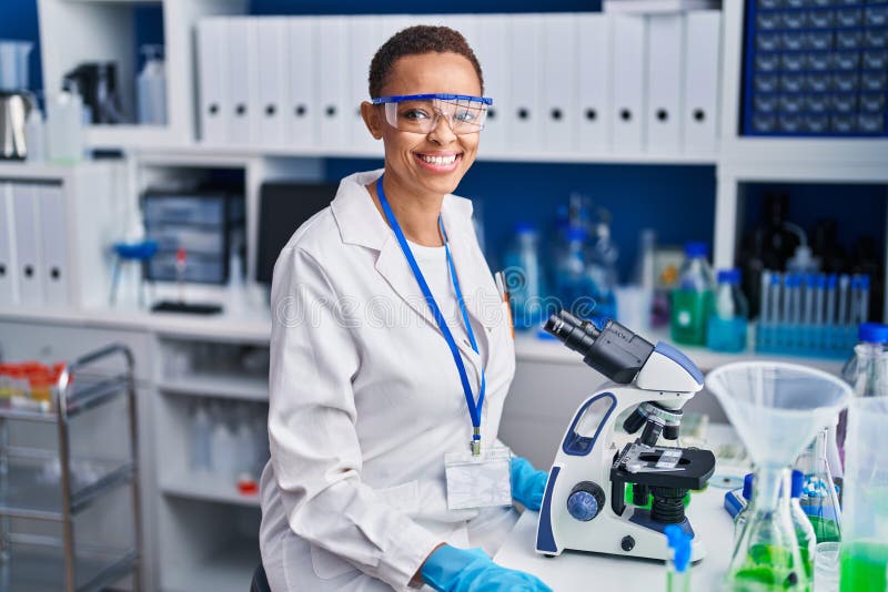 African American Woman Scientist Using Microscope at Laboratory Stock ...