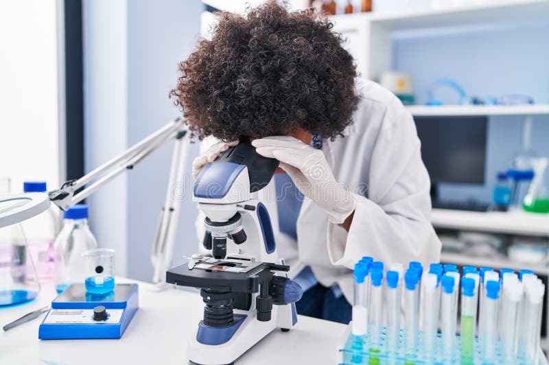 African American Woman Scientist Using Microscope at Laboratory Stock ...