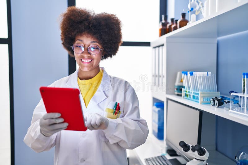 African American Woman Scientist Using Touchpad Working at Laboratory ...