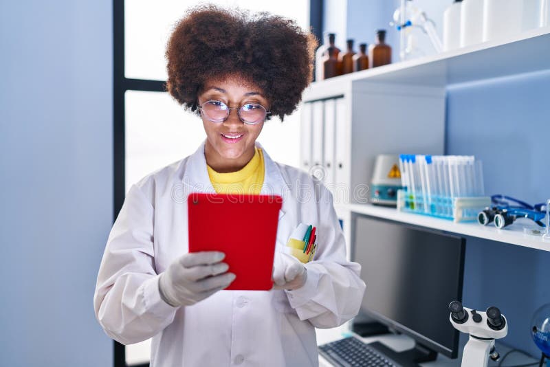 African American Woman Scientist Using Touchpad Working at Laboratory ...