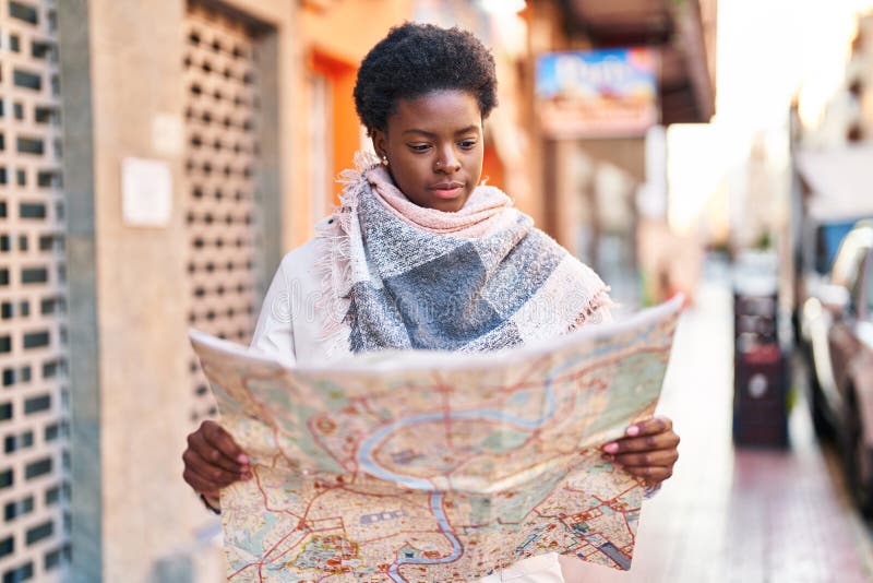 African American Woman Smiling Confident Holding City Map at Street ... African American Woman Smiling Confident Holding City Map at Street ...
