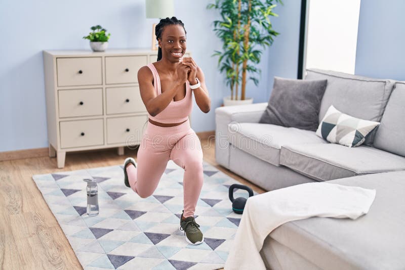 African American Woman Smiling Confident Stretching Legs at Home Stock ... African American Woman Smiling Confident Stretching Legs at Home Stock ...
