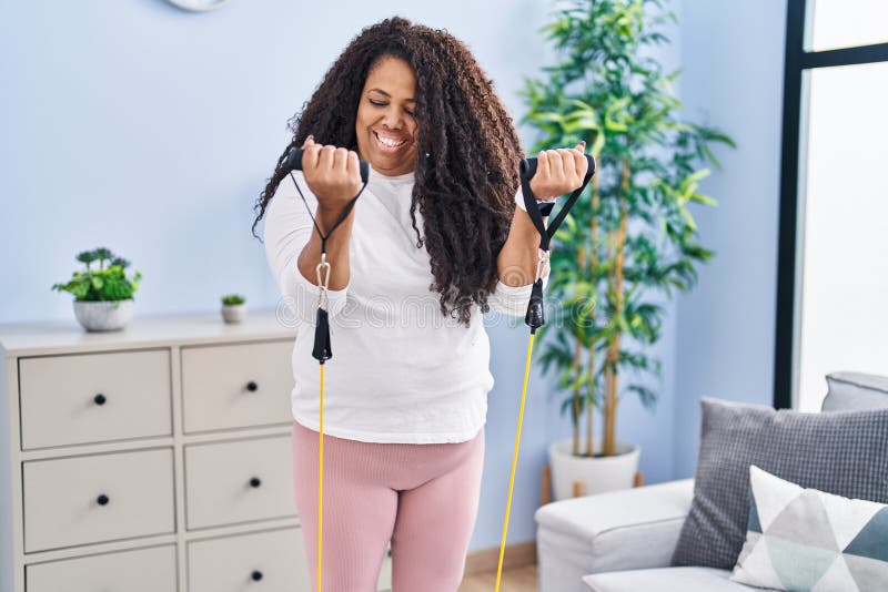 African American Woman Smiling Confident Using Elastic Band Training at ...