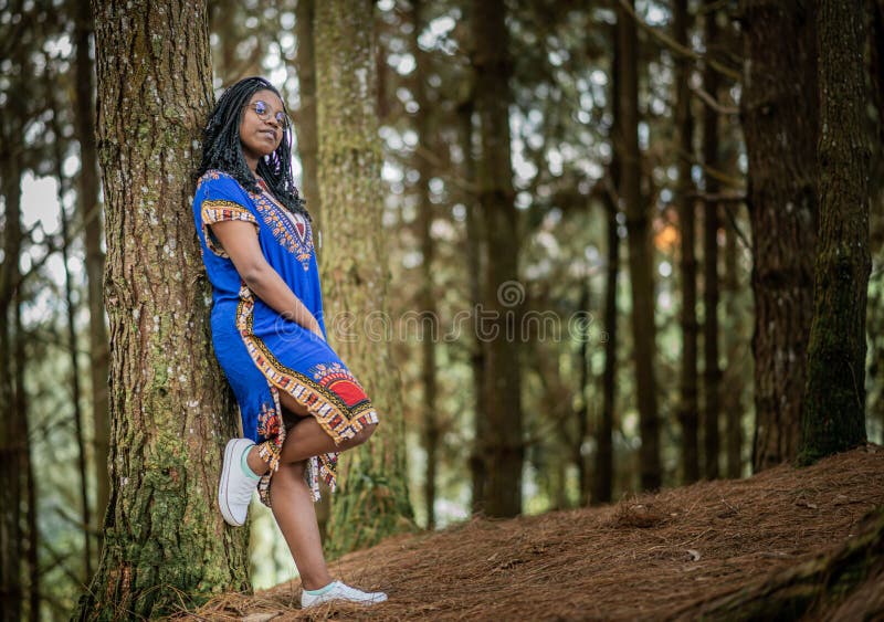 African American Woman Standing by a Tree in a Forest Stock Image ...