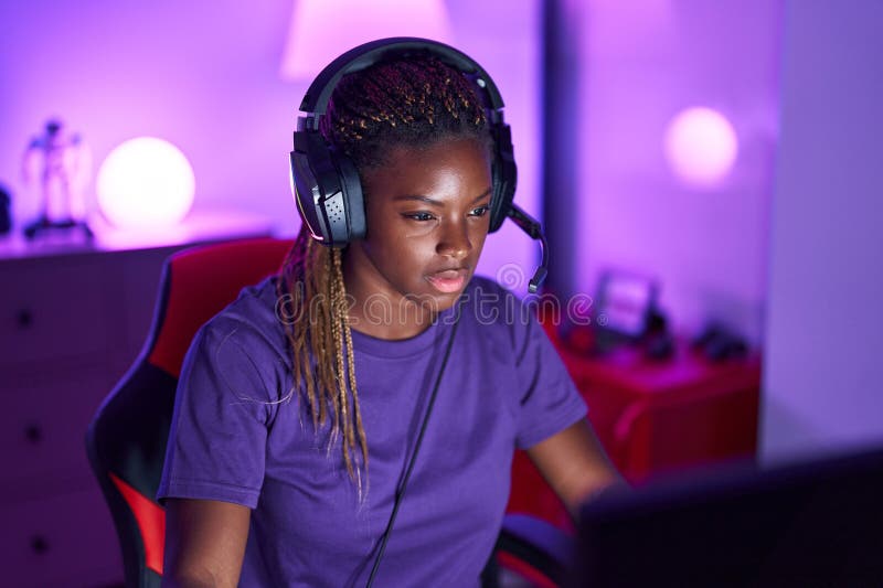 African American Woman Streamer Playing Video Game Using Computer at ...