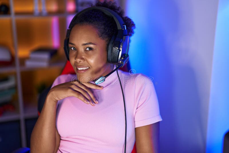 African American Woman Streamer Smiling Confident Sitting on Table at ... African American Woman Streamer Smiling Confident Sitting on Table at ...