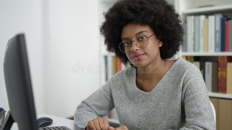 African American Woman Student Using Computer Studying at Library ...