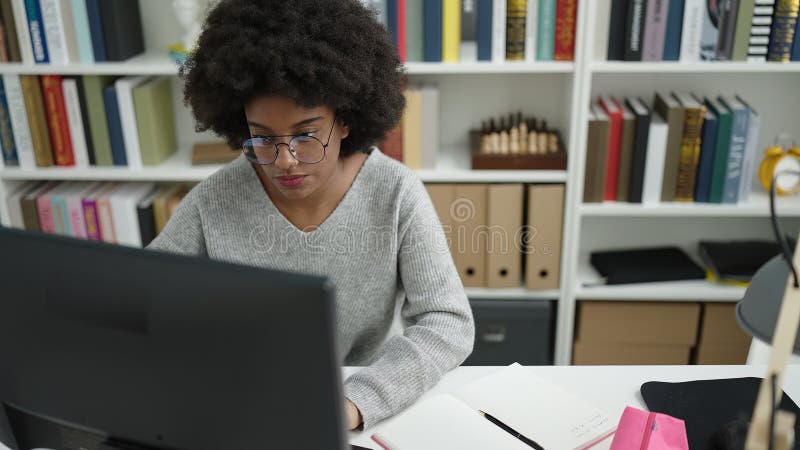 African American Woman Student Using Computer Studying at Library ...
