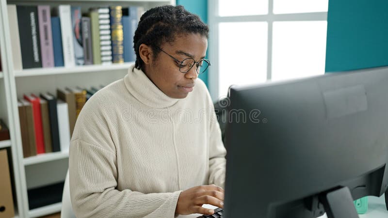 African American Woman Student Using Computer Studying at Library ...