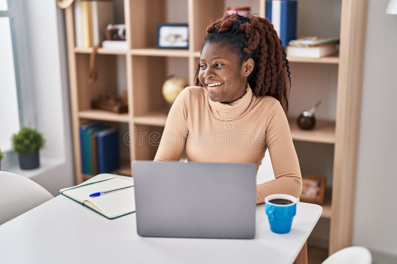 African American Woman Student Using Laptop Studying at Home Stock ...