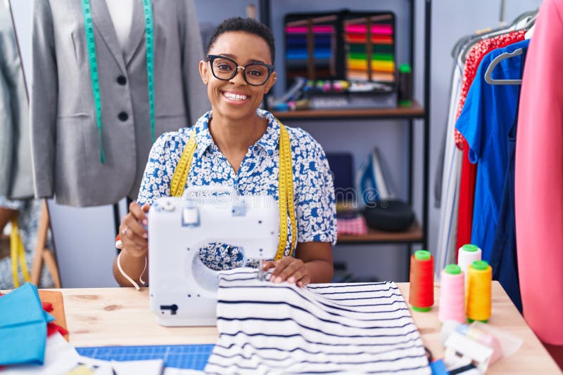 African American Woman Tailor Smiling Confident Using Sewing Machine At