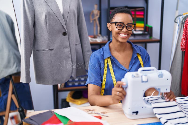 African American Woman Tailor Smiling Confident Using Sewing Machine At